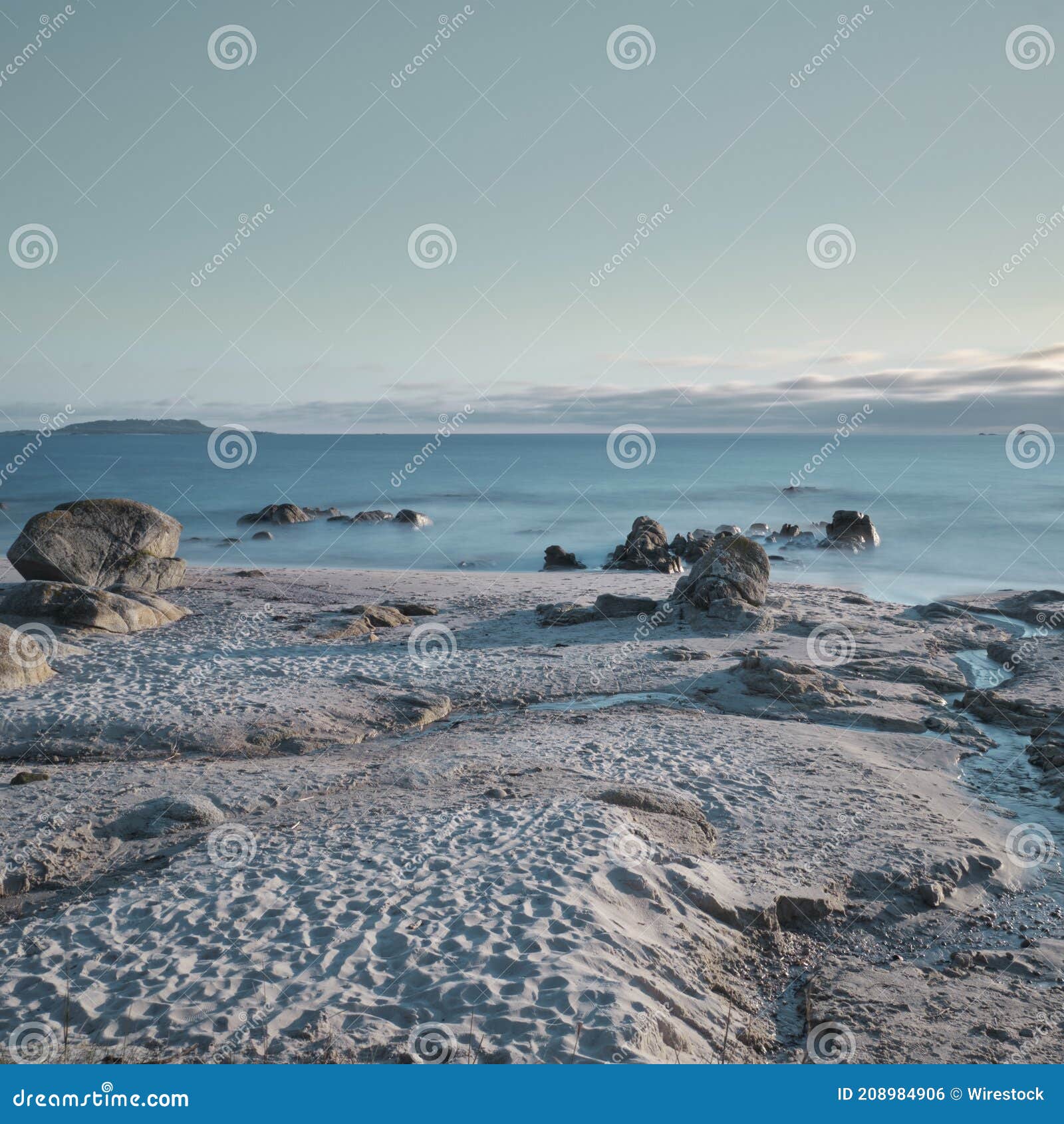 Fantastic Shot of a Sandy and Rocky Beach with a Calm Sea Stock Photo ...