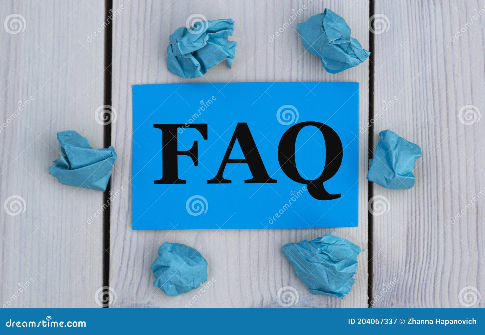 FAQ - Word on Blue Paper on a Light Background with Crumpled Pieces of ...