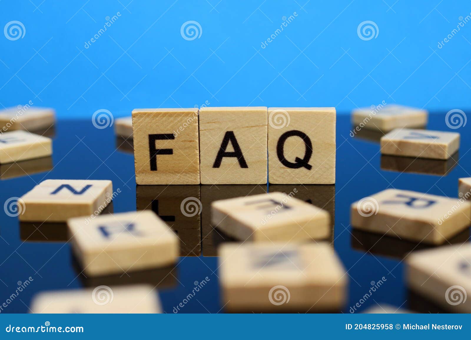 Faq Word Made of Wooden Letters on a Mirror Surface on a Blue ...