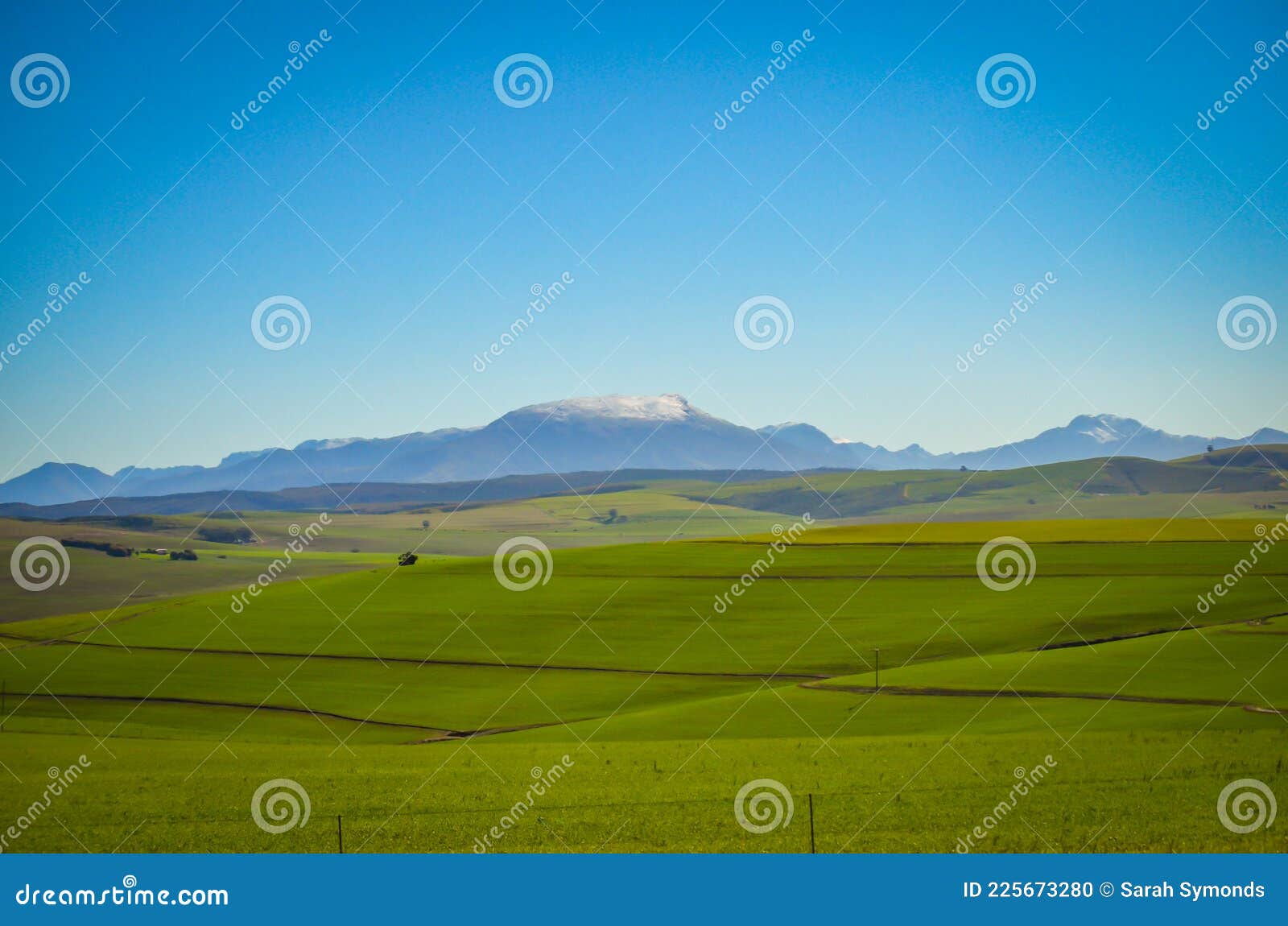 Farm land and mountains stock photo. Image of landscape - 225673280