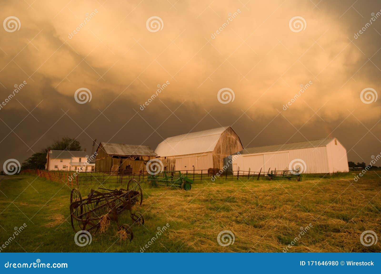 Farm with Old Barns Surrounded by the Lawn Under a Cloudy Sky during ...