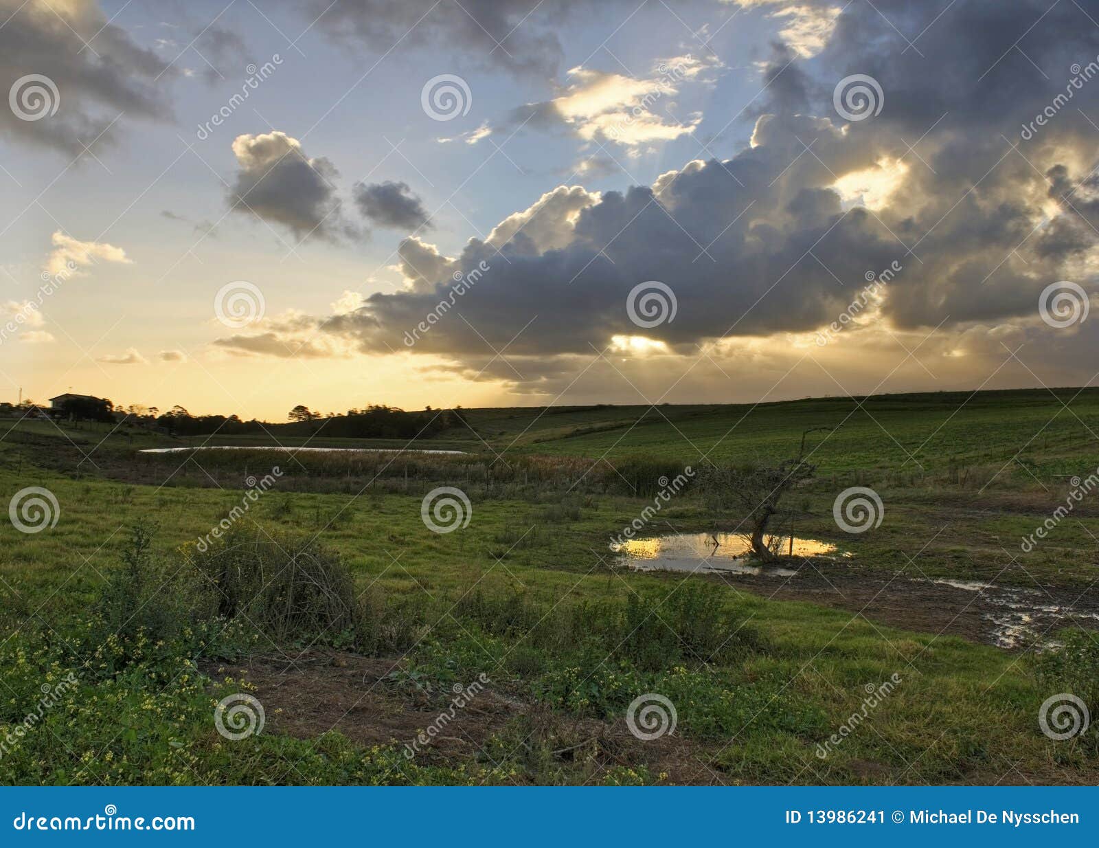 Farm Sunset with Grey Clouds and Sun Rays Landscap Stock Image - Image ...