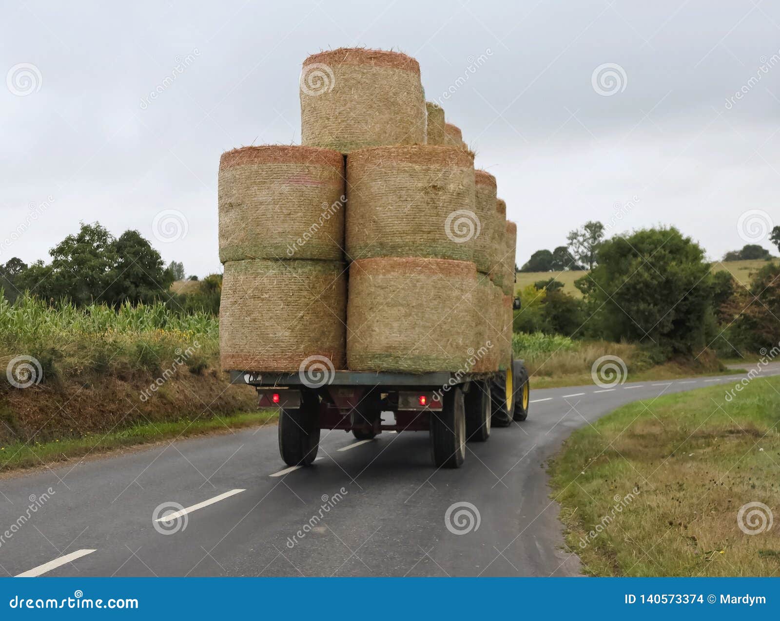 Farm Tractor with Trailer of Hay Bales Stock Photo - Image of rolled ...