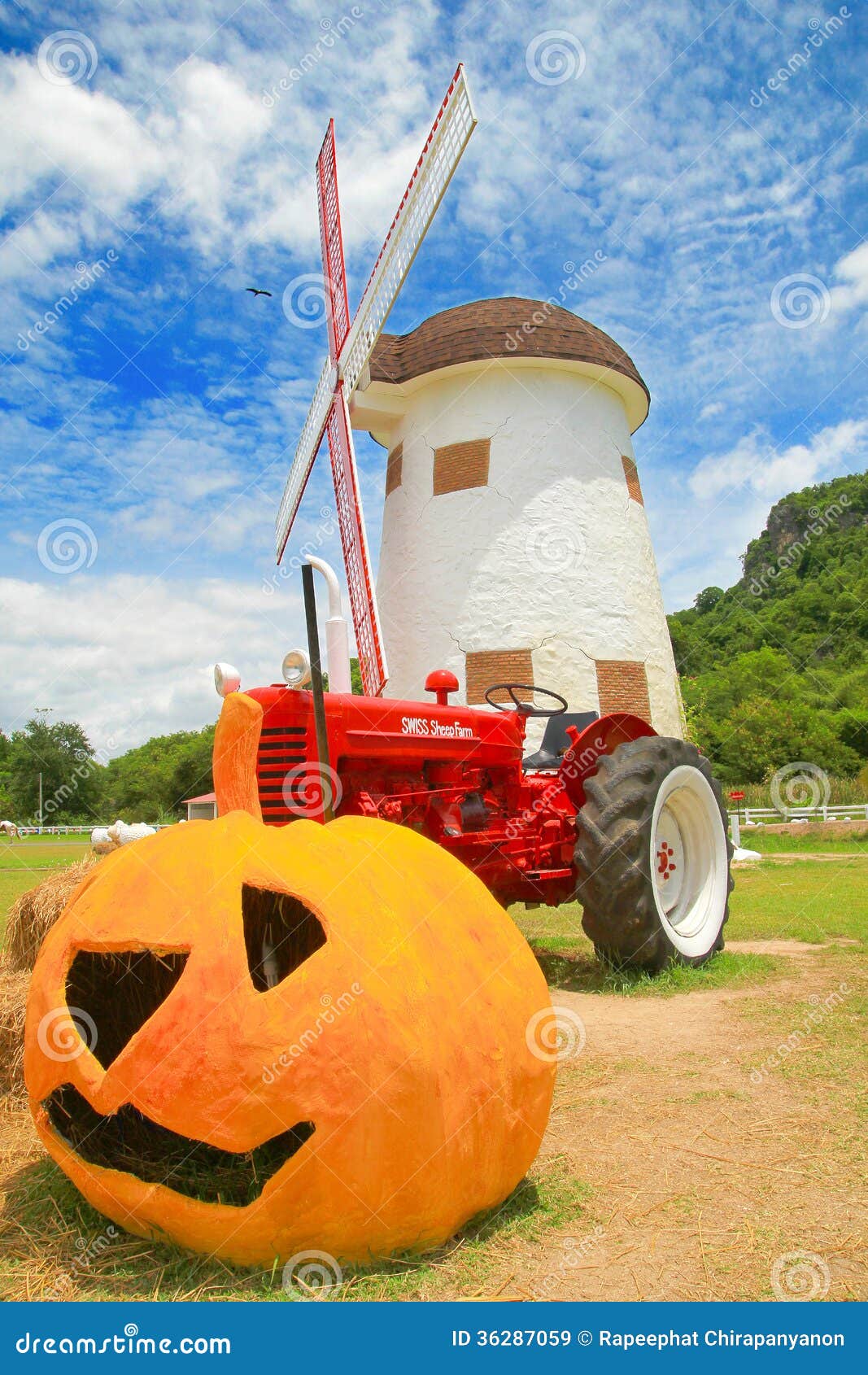 Windmill and Red Tractor in Farm with Blue Sky and Green Nature ...