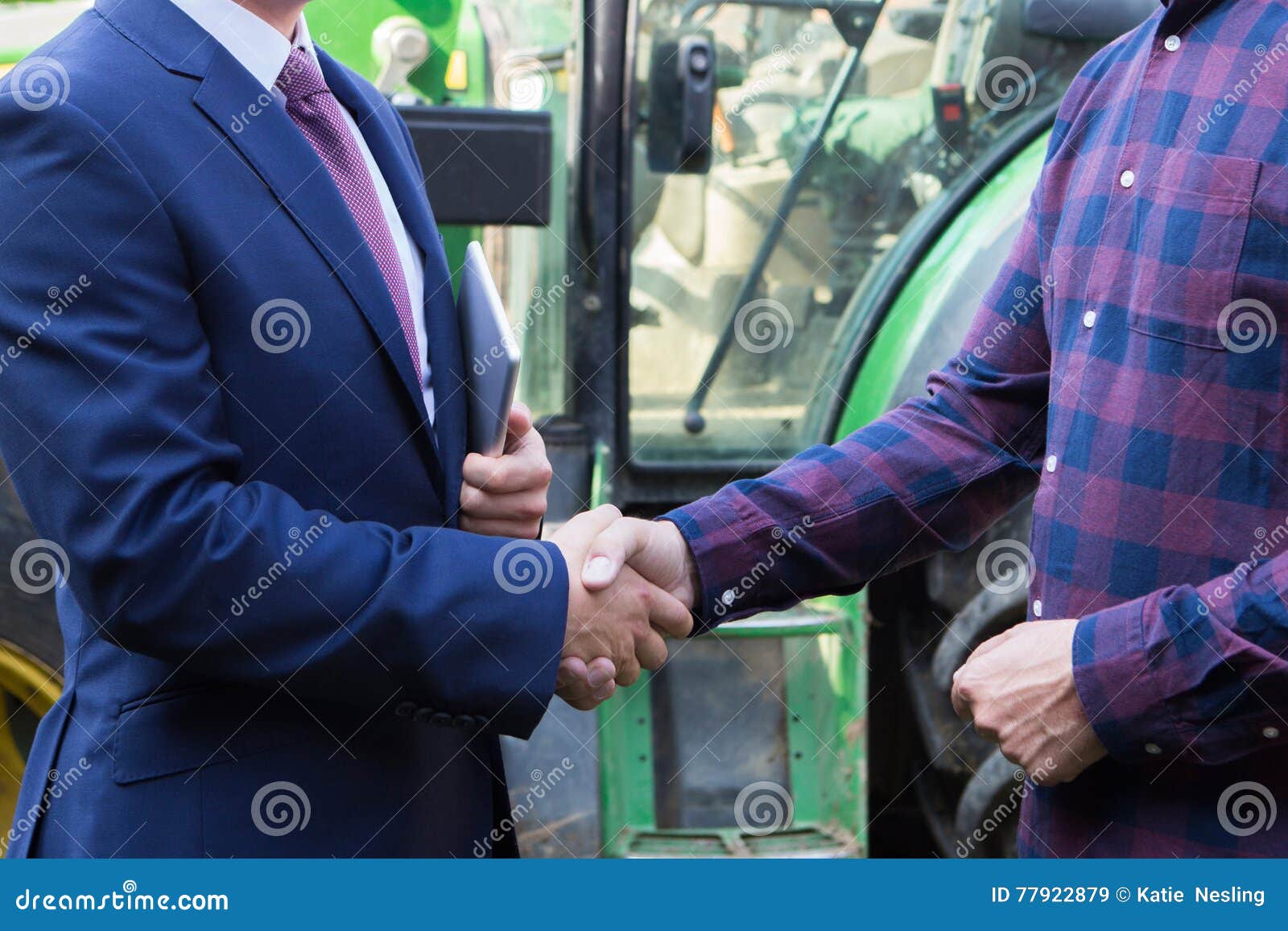 Farmer and Businessman Shaking Hands with Tractor in Background Stock ...