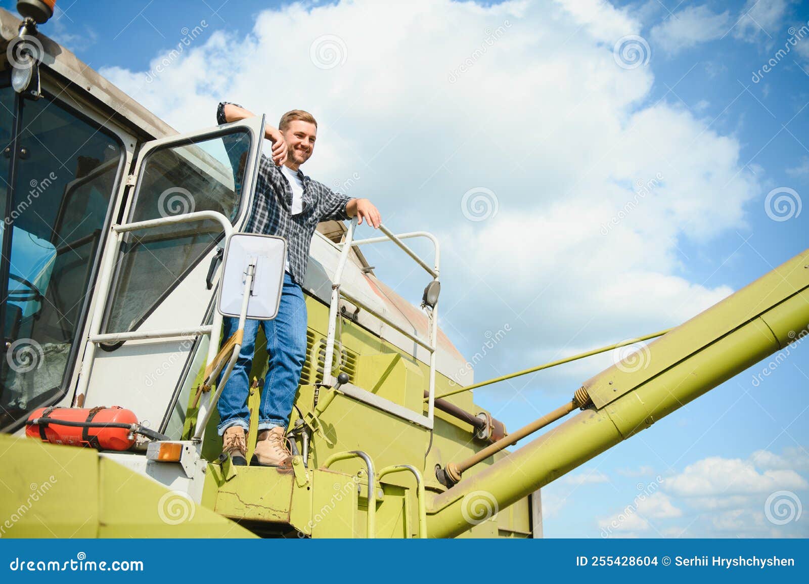 Farmer Controls the Combine Harvester. Stock Photo - Image of ...