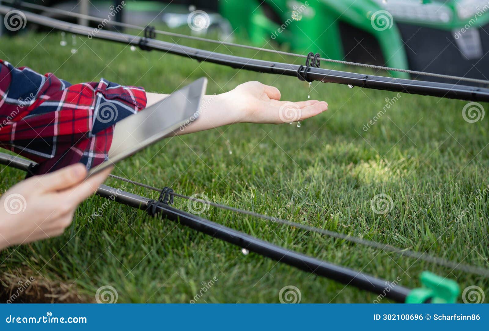 Farmer Controls Drip Irrigation System with Digital Tablet Stock Photo ...