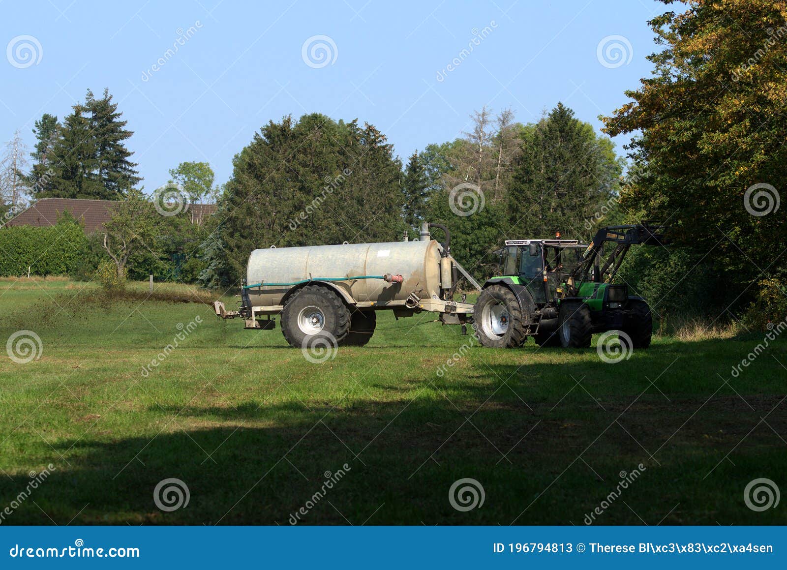 Farmer distributing manure stock image. Image of vehicle - 196794813