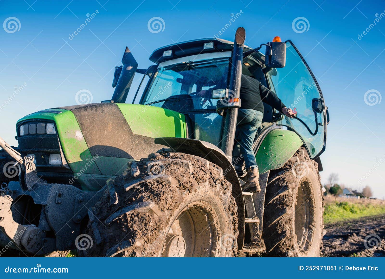 Farmer Getting on His Tractor To Go To Work in the Fields Stock Image ...