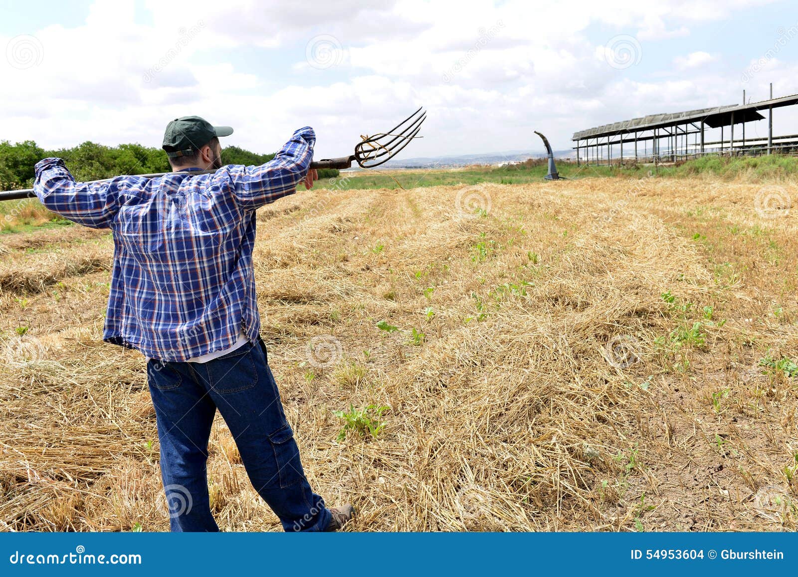 Farmer Holding a Fork and Looking on His Field Stock Photo - Image of ...