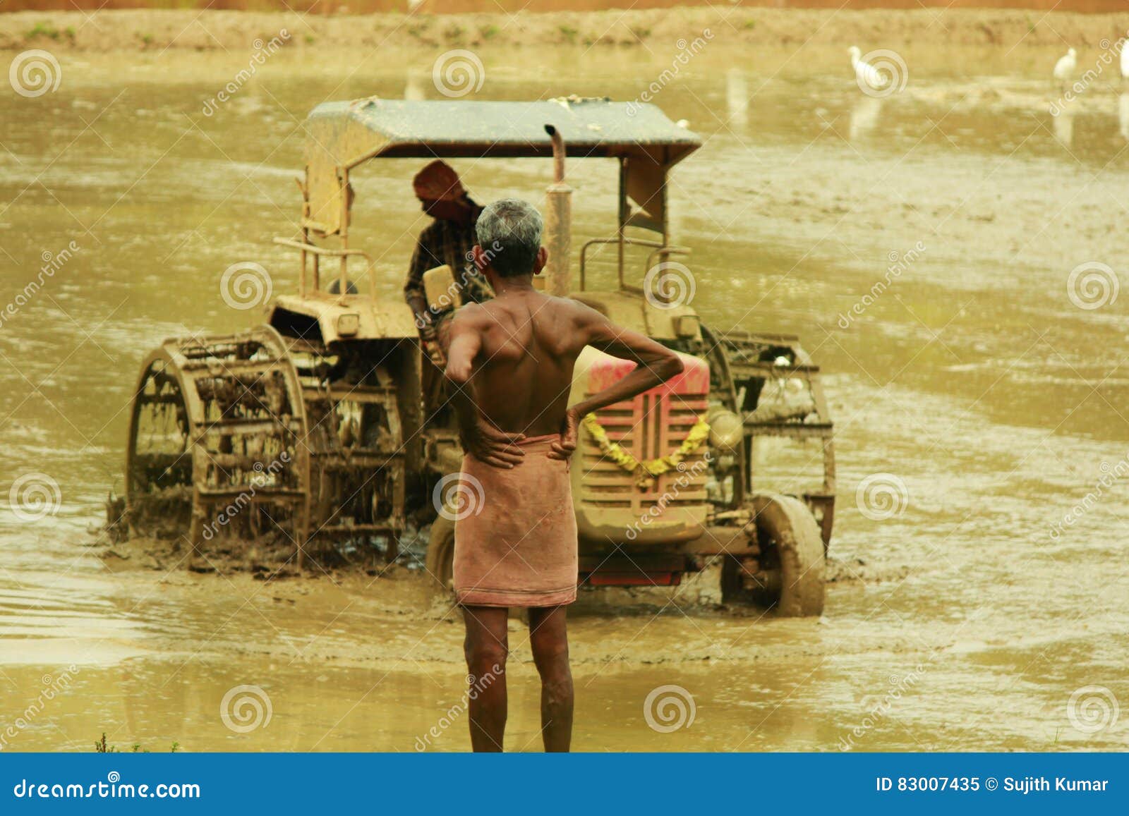 Farmer and machine editorial image. Image of tractor - 83007435