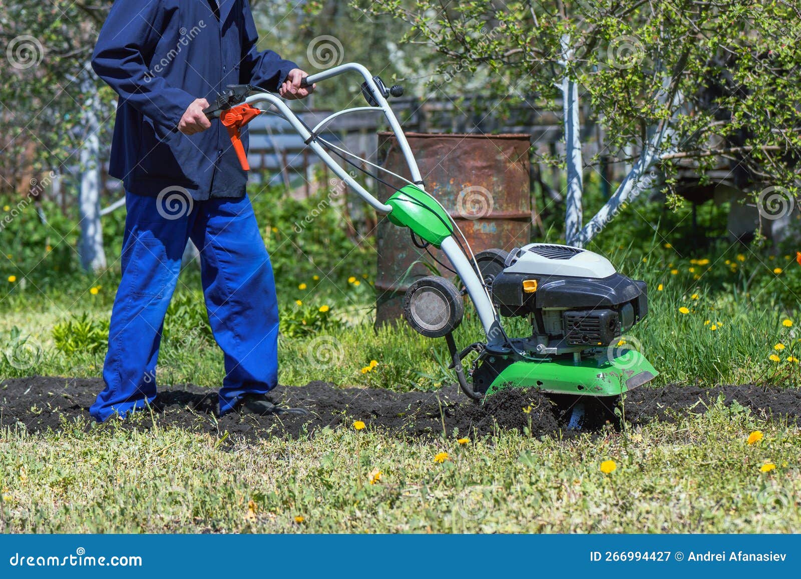 Farmer Man Plows the Land with a Cultivator Preparing the Soil for ...