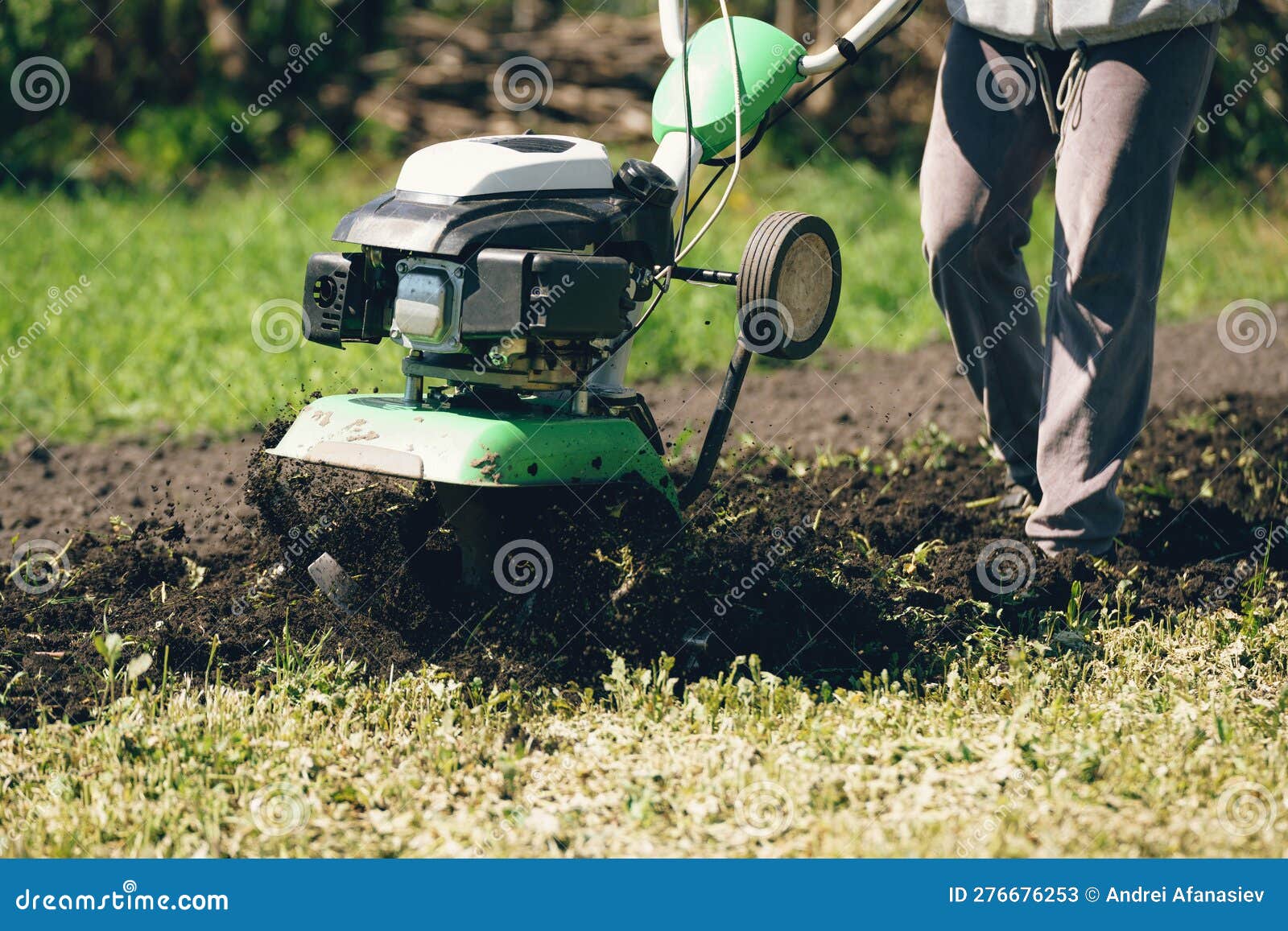 Farmer Man Plows the Land with a Cultivator Preparing the Soil for ...