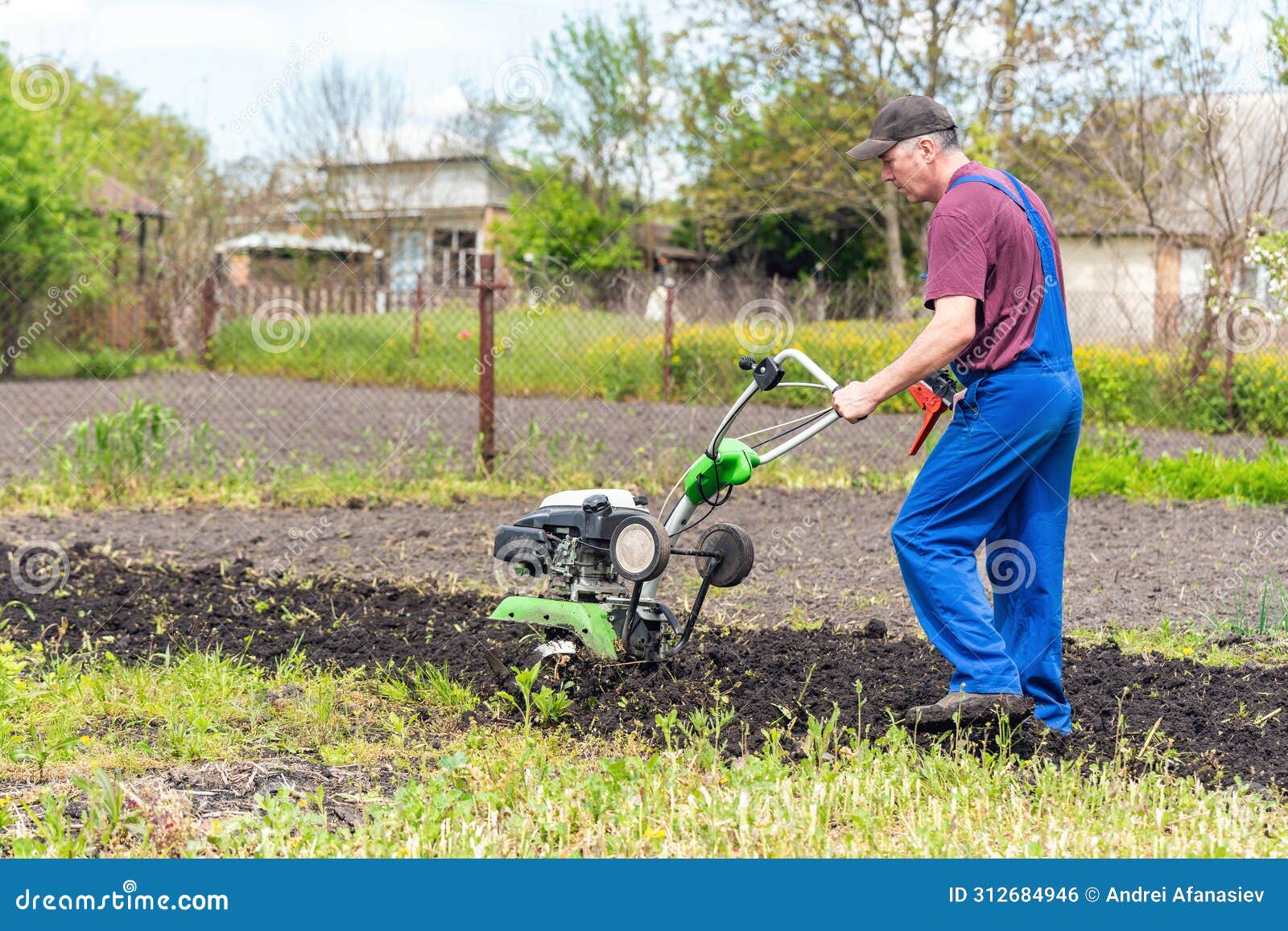 Farmer Man Plows the Land with a Cultivator Preparing the Soil for ...