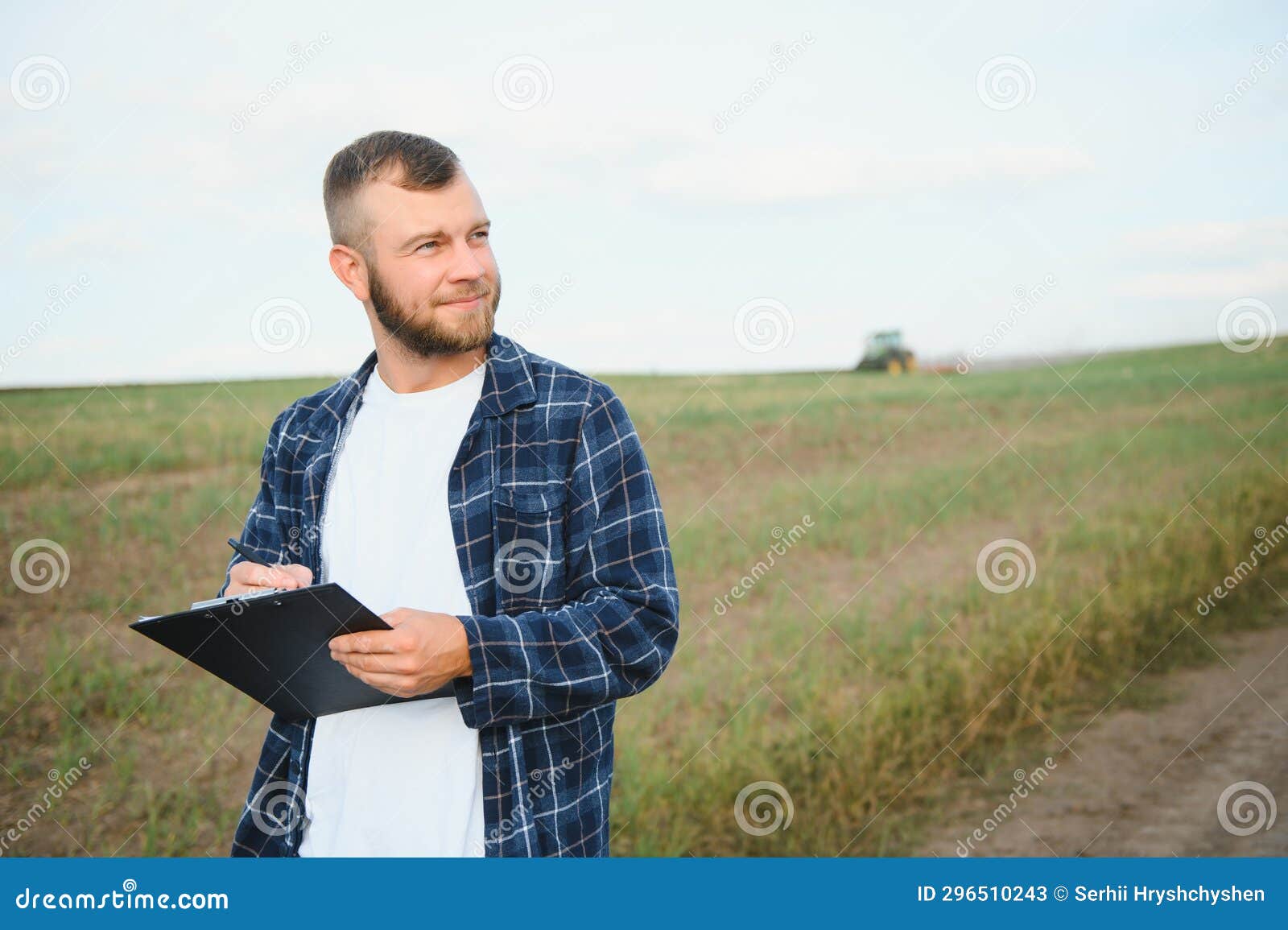 Farmer in a Plaid Shirt Controlled His Field and Writing Notes. Stock ...