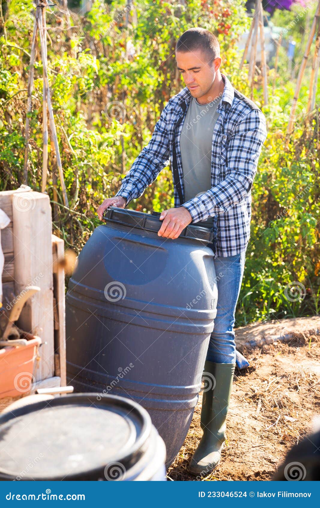 Farmer with a Plastic Barrel in Summer Garden Stock Photo - Image of ...
