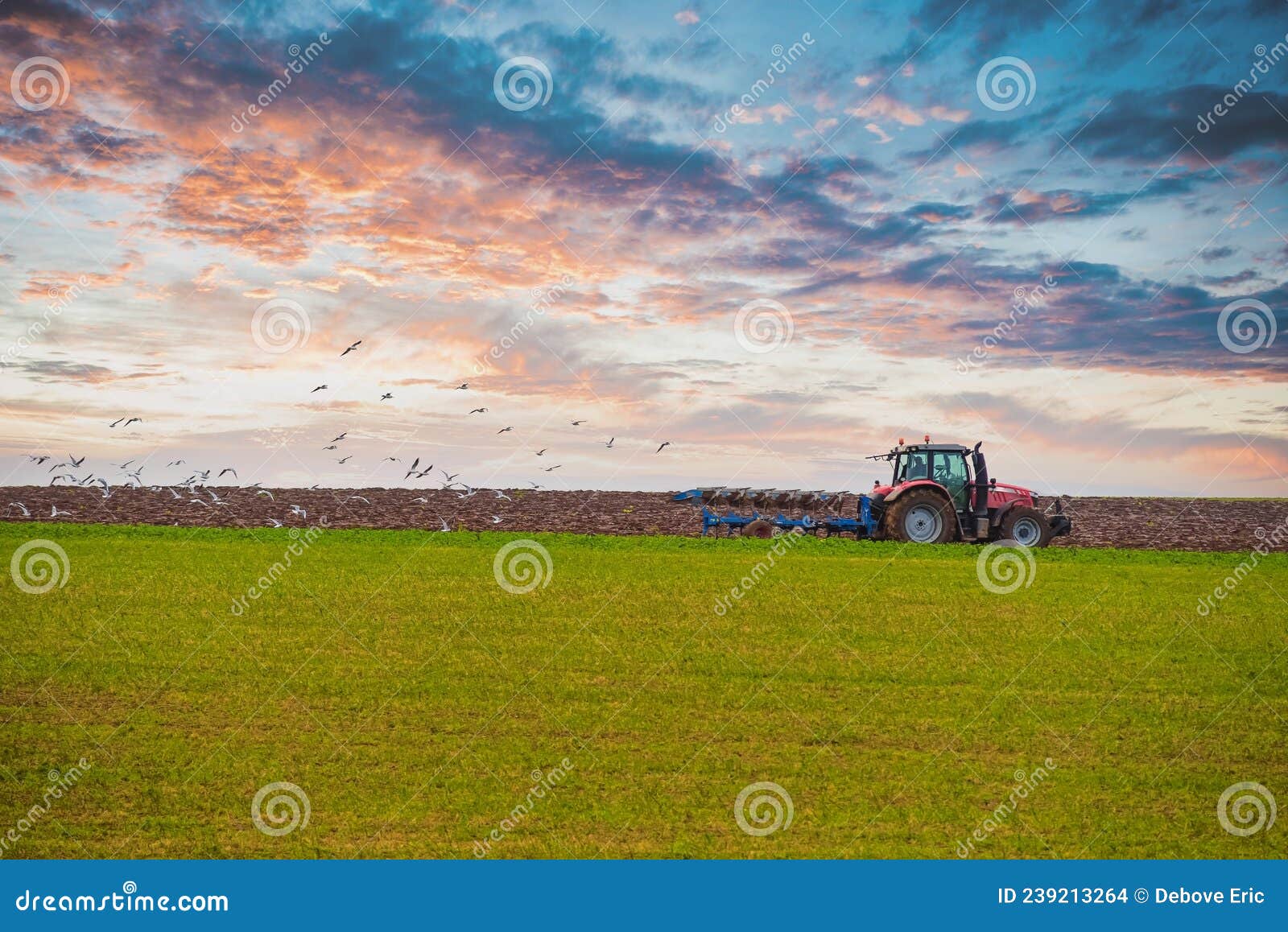 Landscape with a Tractor Equipped with a Plow in Action in a Field at ...