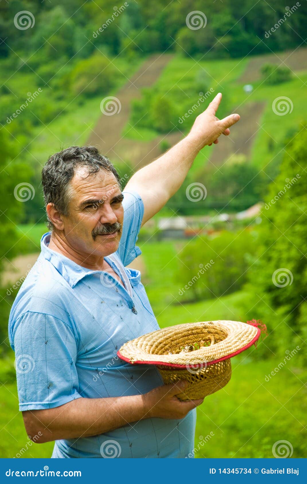 Farmer Pointing To His Plowing Land on Hill Stock Photo - Image of ...