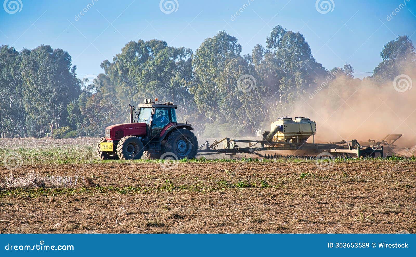 Farmer Pulling a Harrow Behind a Tractor in a Farm Field Editorial ...