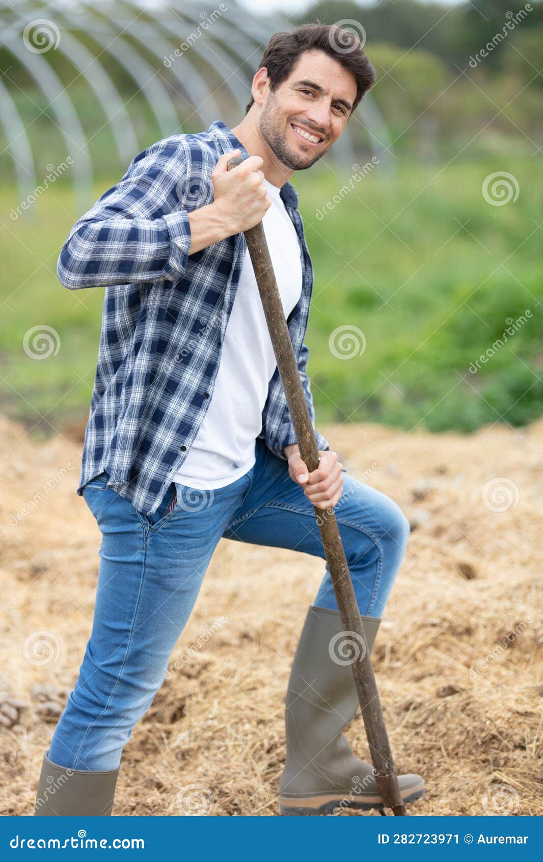 Farmer Standing Outside by Greenhouse Using Fork Stock Image - Image of ...