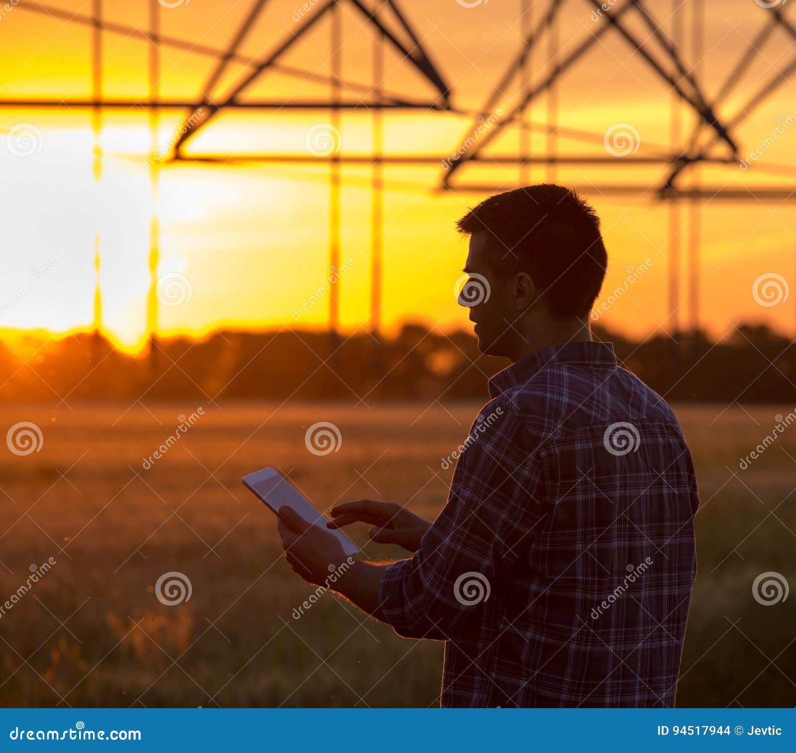 Farmer with Tablet in Field at Sunset Stock Photo - Image of agronomy ...