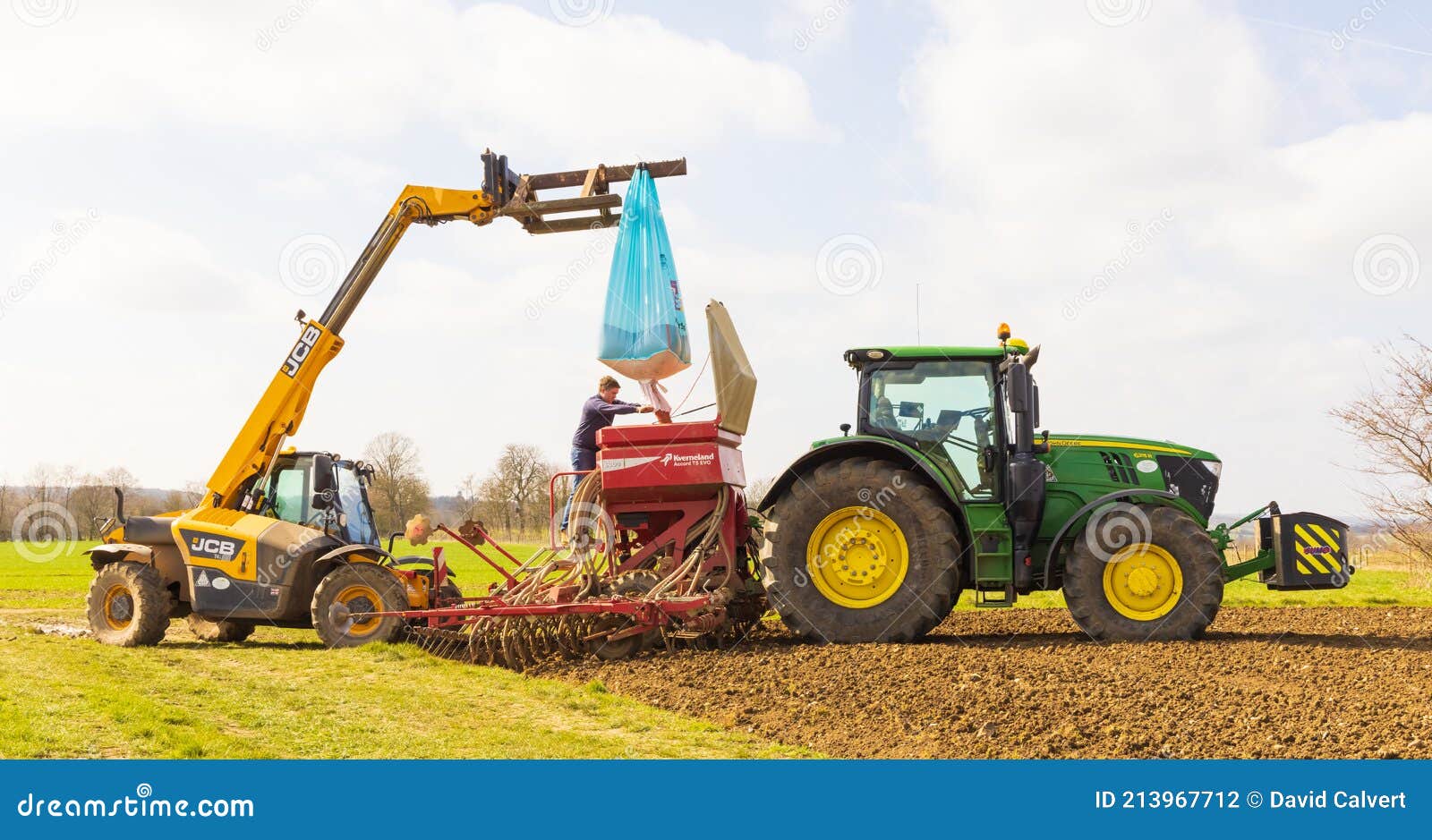 Farmer with a Telehandler Loading Seeds into a Seeder Driller Attached ...