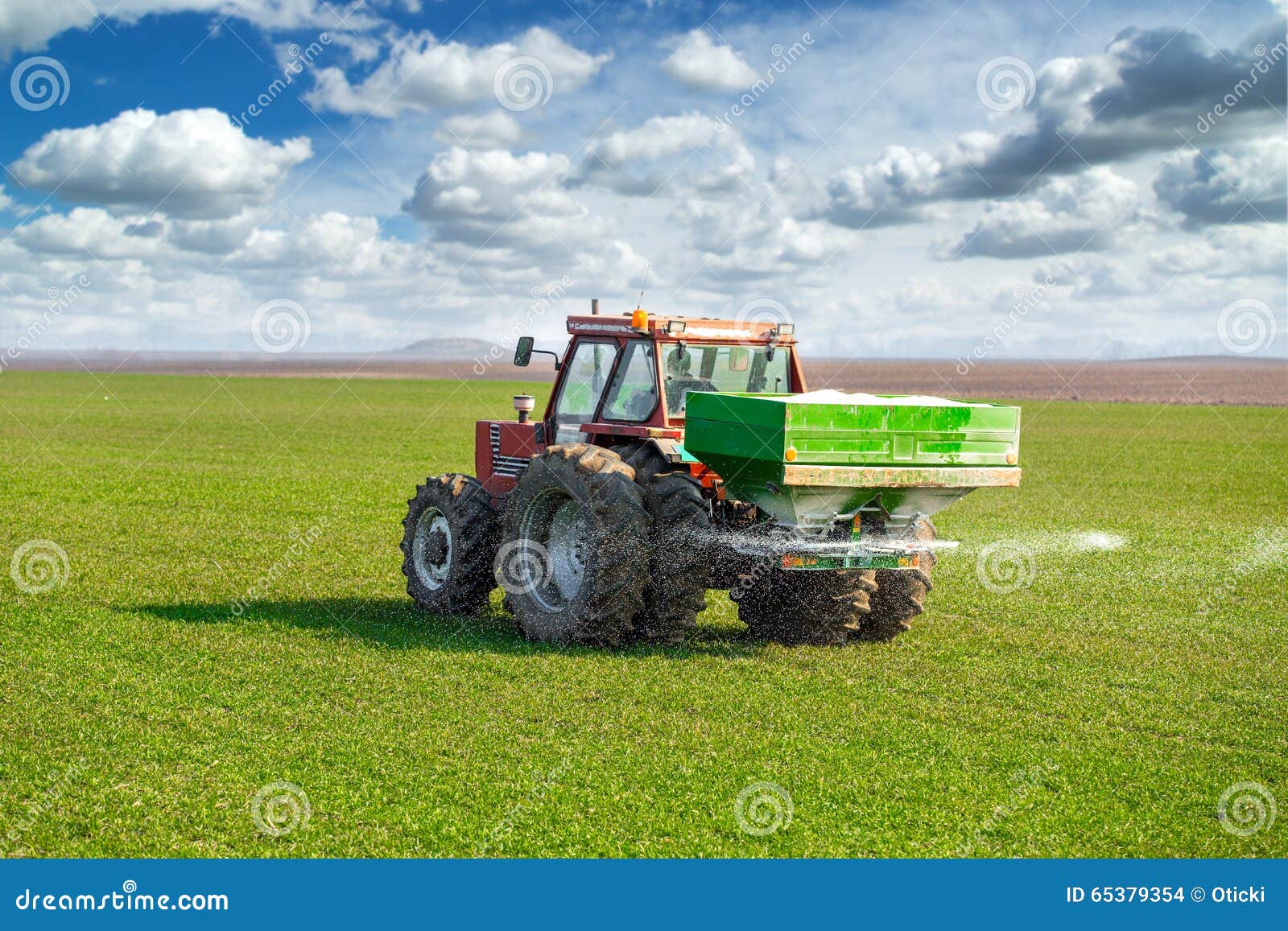 Farmer in Tractor Fertilizing Wheat Field at Spring with Npk. Stock ...