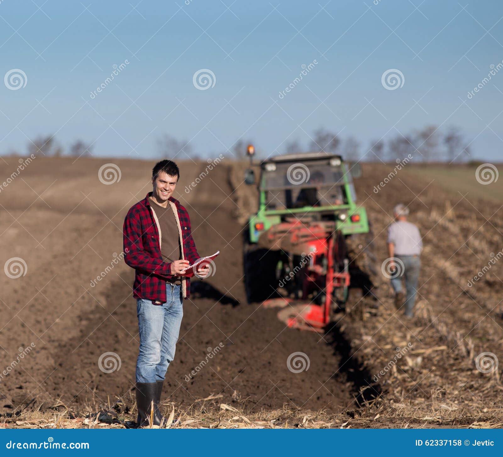 Farmer with Tractor on Field Stock Photo - Image of calculating, happy ...