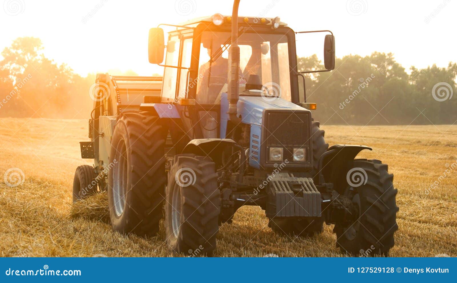 Farmer on Tractor Harvesting Field at the Evening. Stock Photo - Image ...
