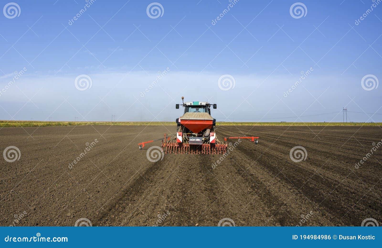 Farmer with Tractor Seeding Crops at Field Stock Photo - Image of ...