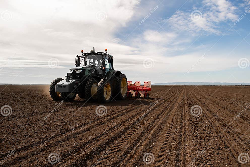 Farmer with Tractor Seeding Crops at Field Stock Photo - Image of ...