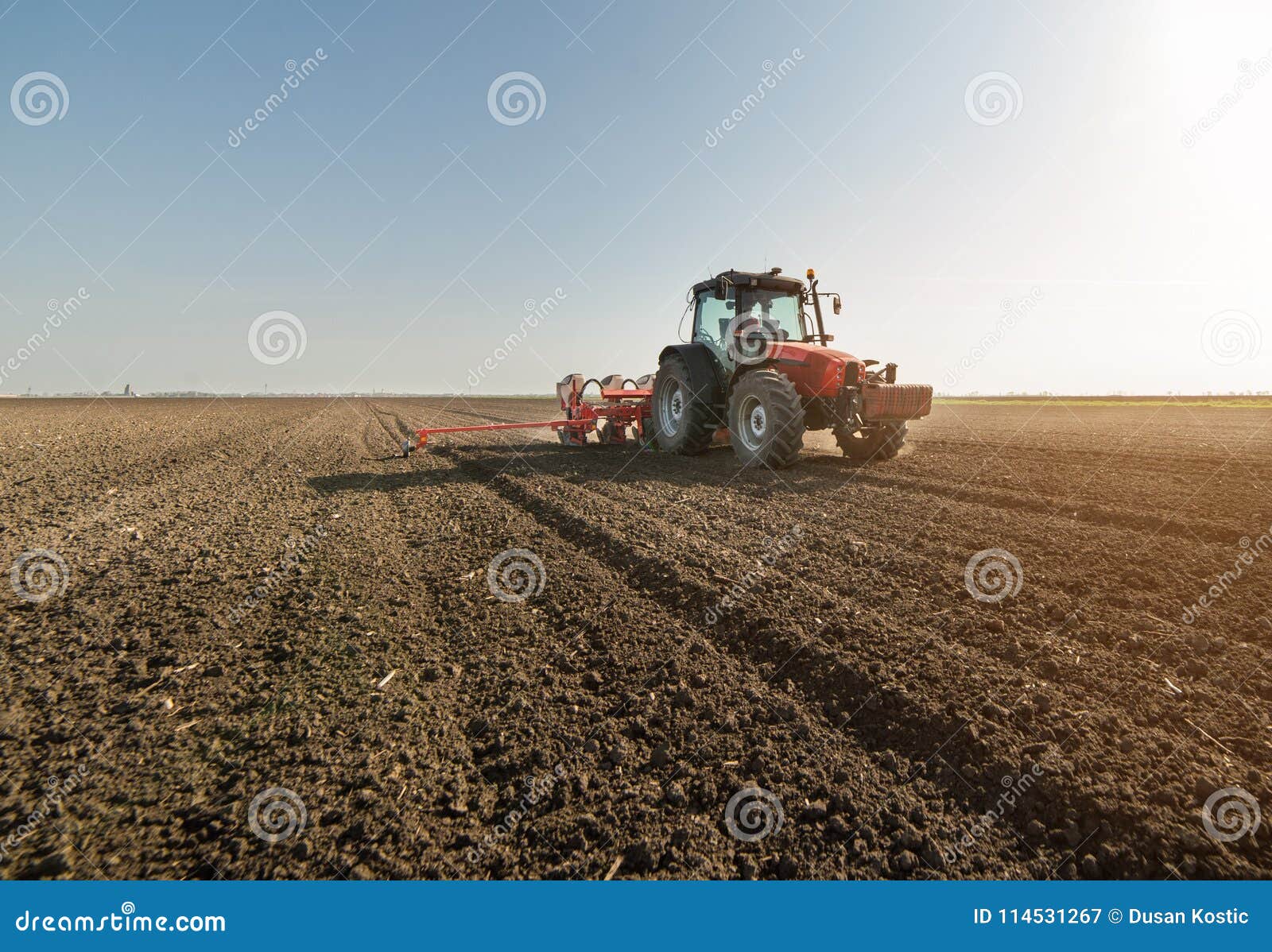 Farmer with Tractor Seeding - Sowing Crops at Agricultural Field ...