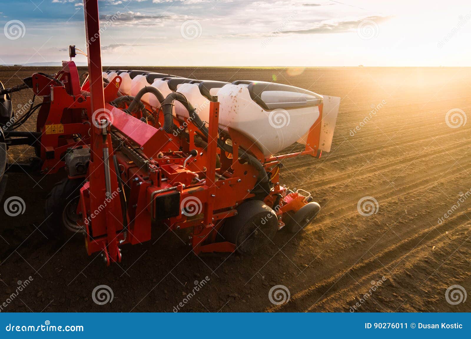 Farmer with Tractor Seeding - Sowing Crops at Agricultural Field Stock ...