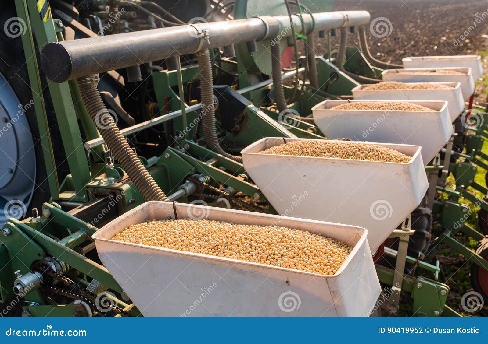 Farmer with Tractor Seeding - Sowing Crops at Agricultural Field Stock ...