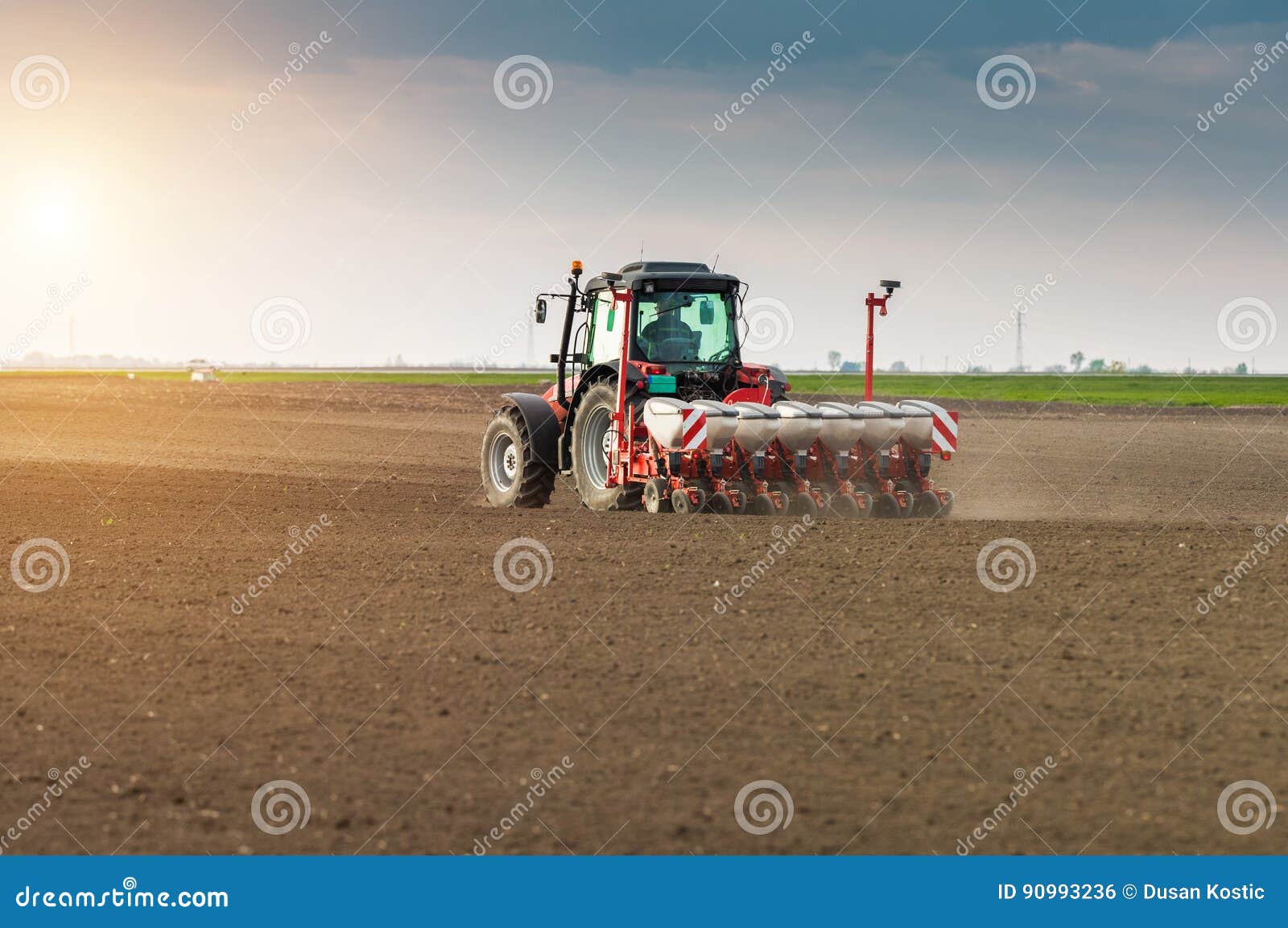 Farmer With Tractor Seeding - Sowing Crops At Agricultural Field Stock ...