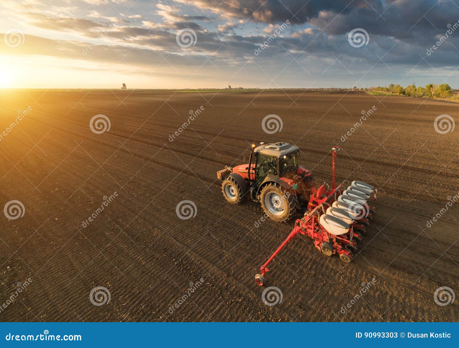 Farmer with Tractor Seeding - Sowing Crops at Agricultural Field Stock ...