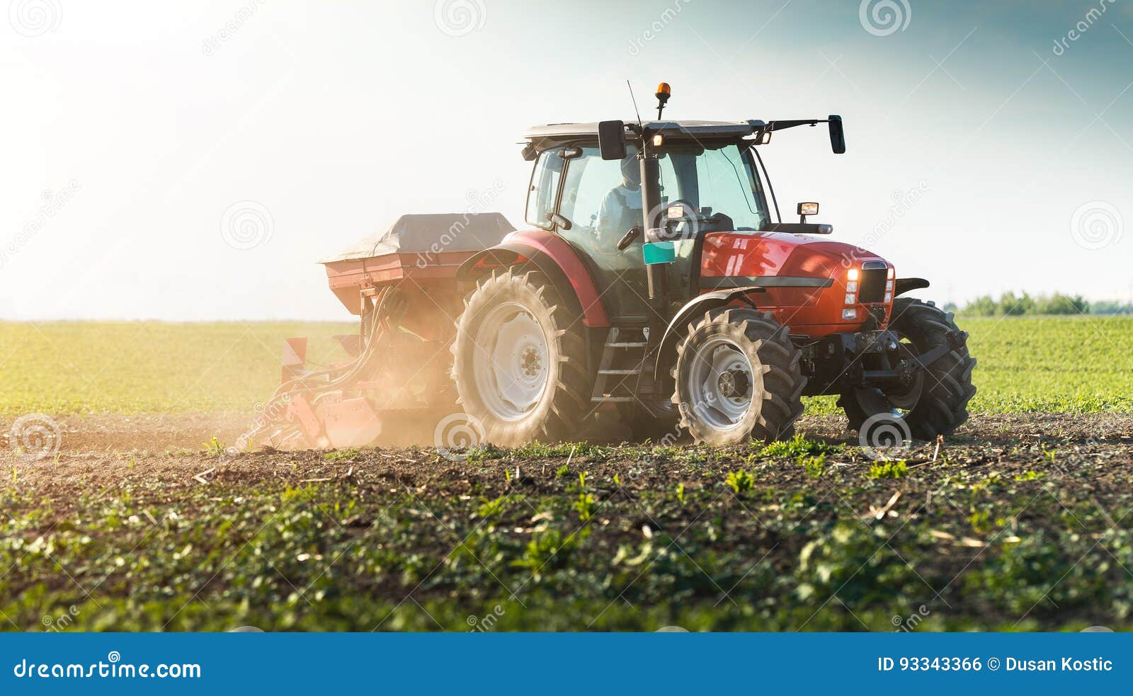 Farmer with Tractor Seeding - Sowing Crops at Agricultural Field Stock ...