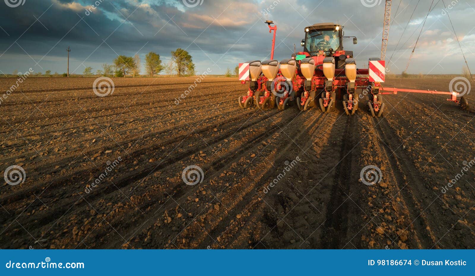 Farmer with Tractor Seeding - Sowing Crops at Agricultural Field Stock ...
