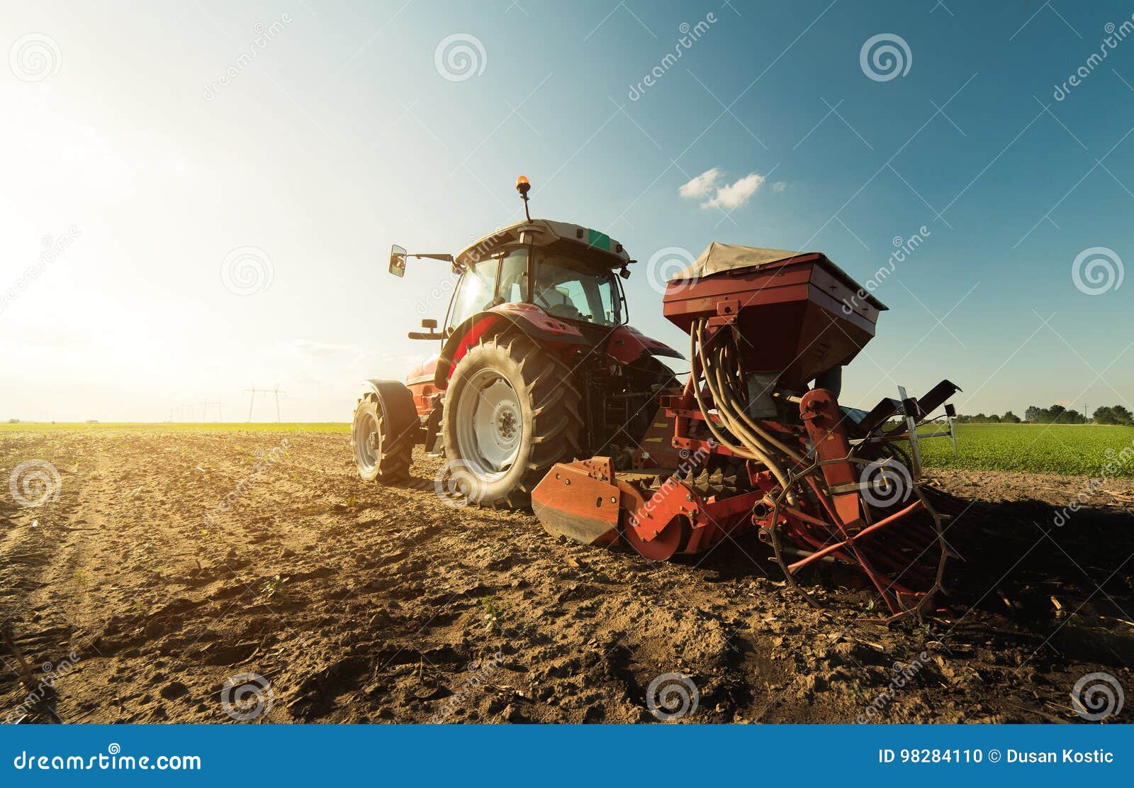 Farmer with Tractor Seeding - Sowing Crops at Agricultural Field Stock ...