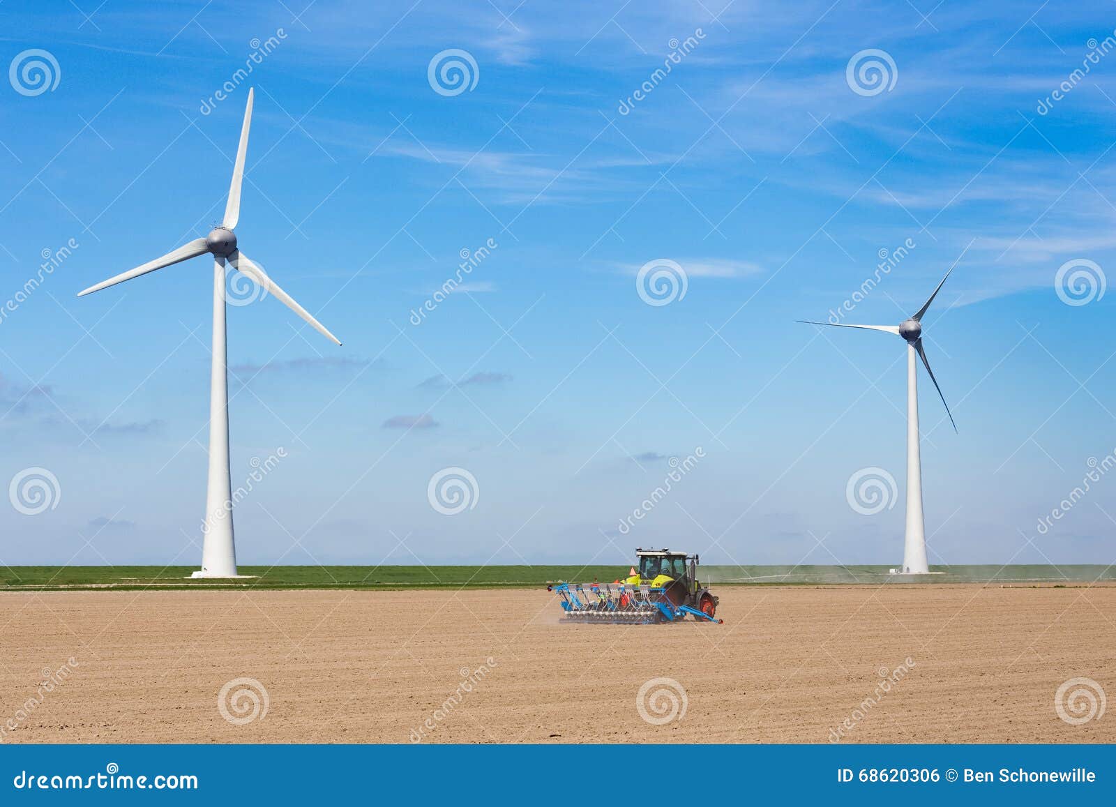 Farmer on Tractor Sowing in Soil Near and Windmills Stock Photo - Image ...