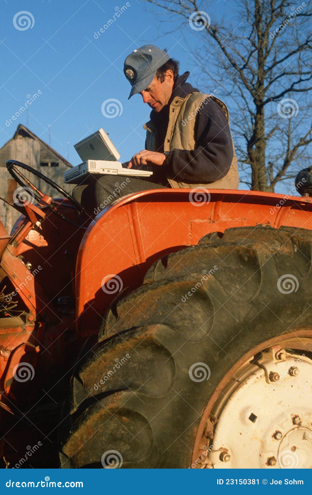 Farmer on Tractor Working on Laptop Computer Editorial Photo - Image of ...