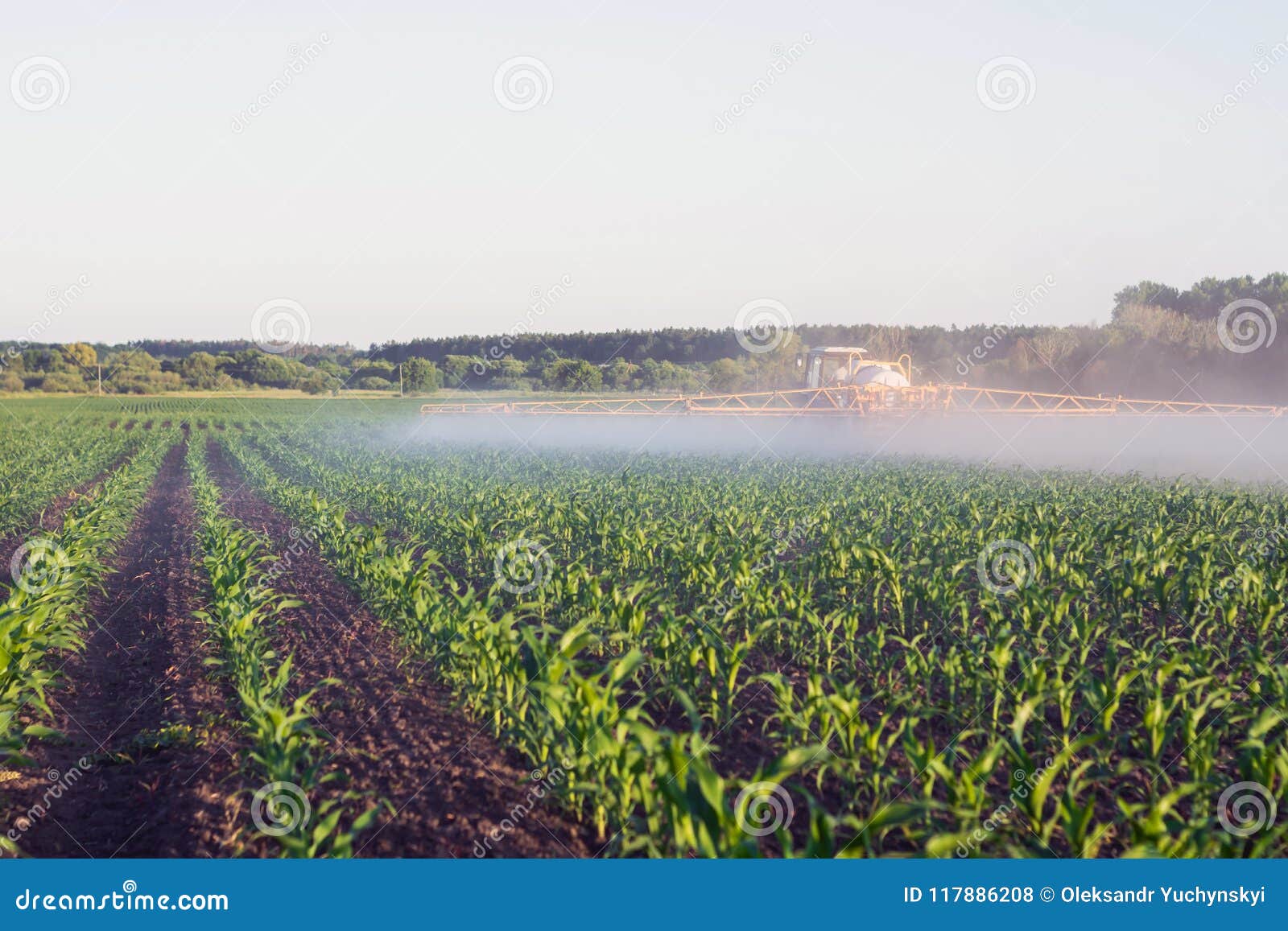 The Farmer on the Trailed Sprayer Introduces Microfertilizer on the ...