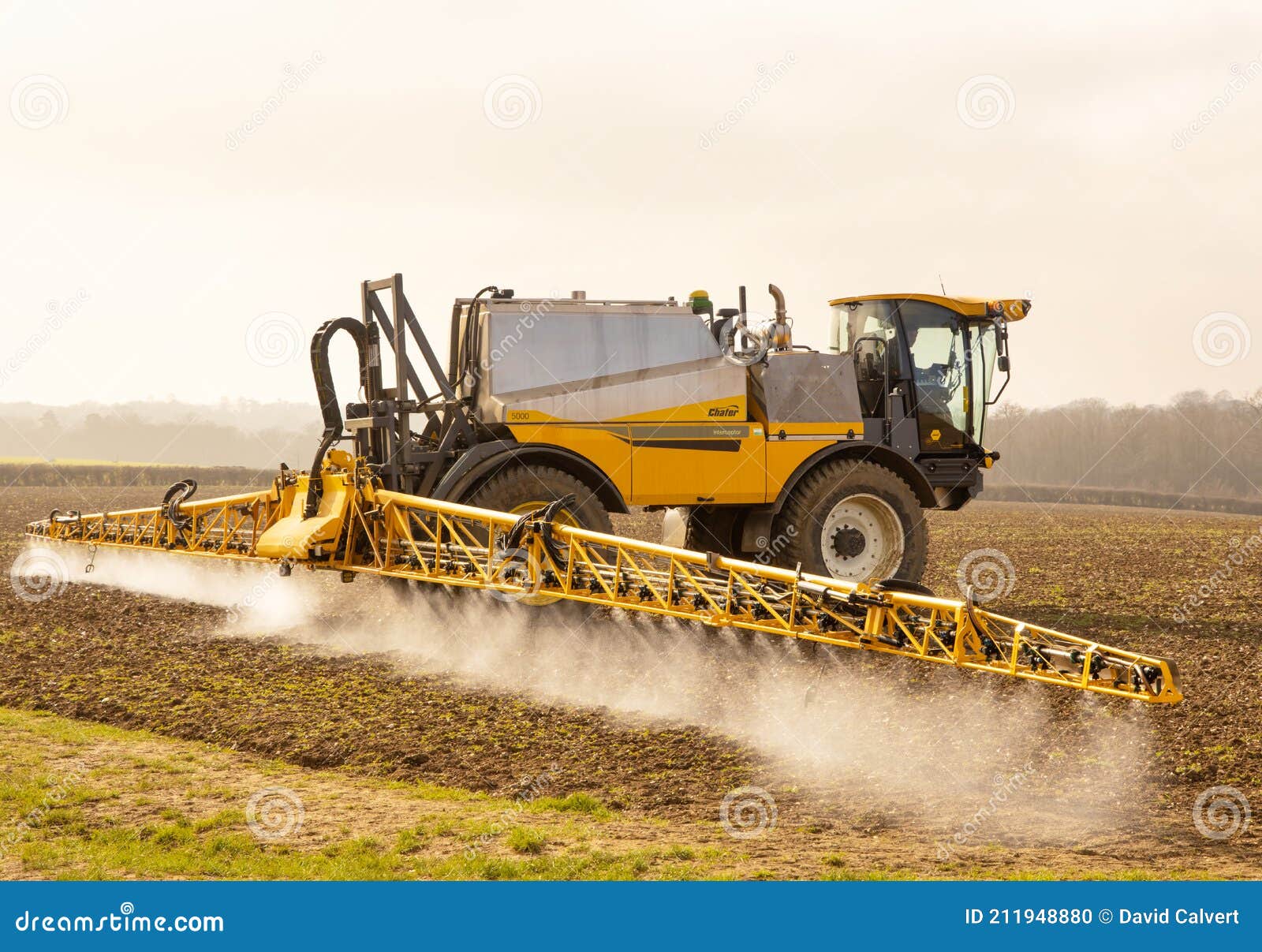 Farmer Using a Self Propelled Crop Sprayer in a Field in Early Spring ...