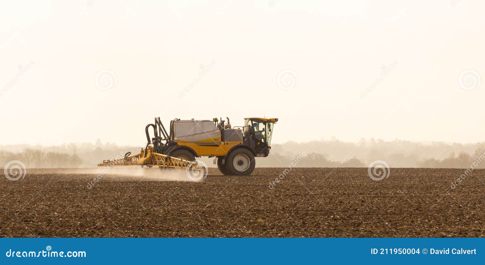 Farmer Using a Self Propelled Crop Sprayer in a Field in Early Spring ...