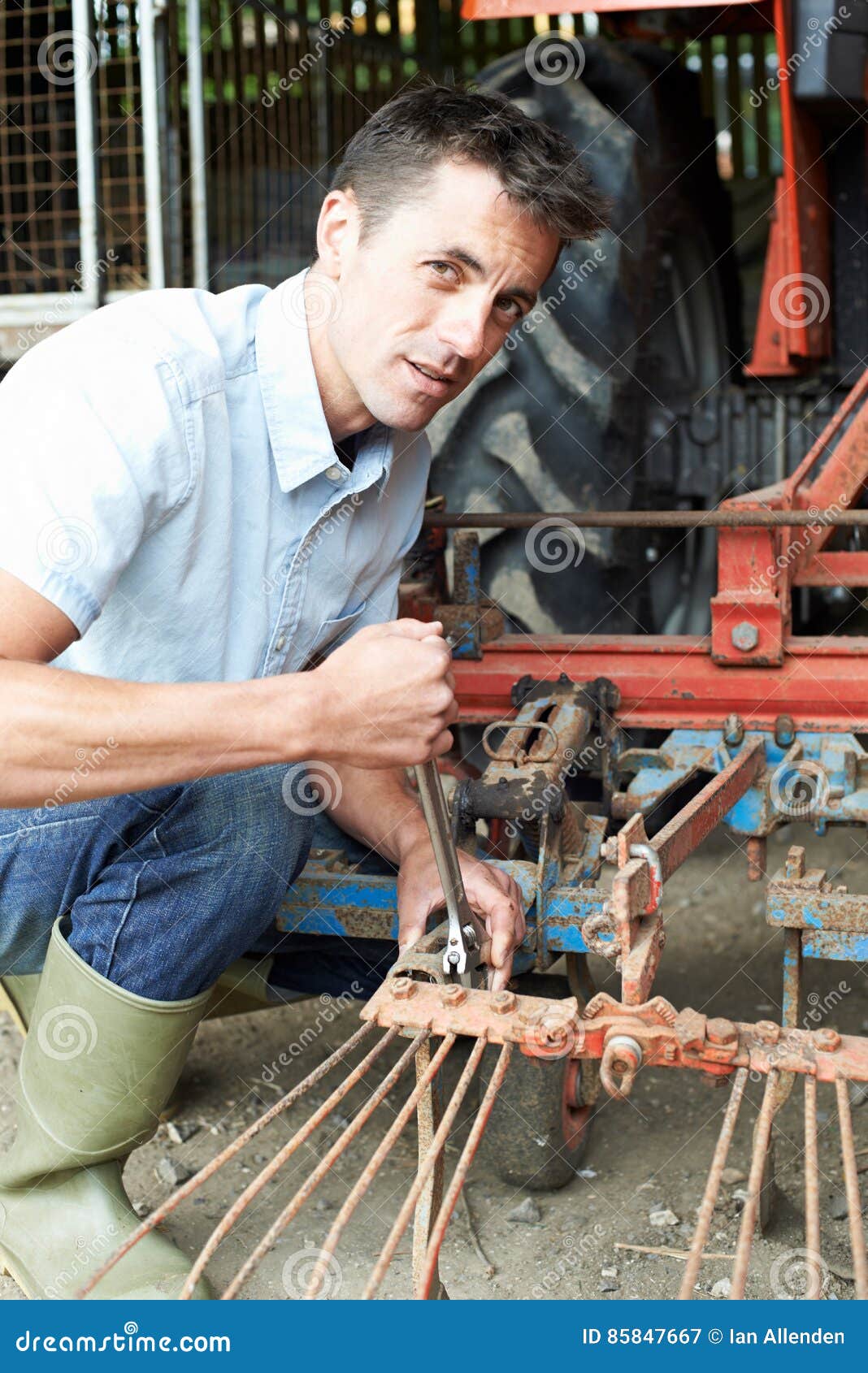 Farmer Working on Agricultural Equipment in Barn Stock Image - Image of ...
