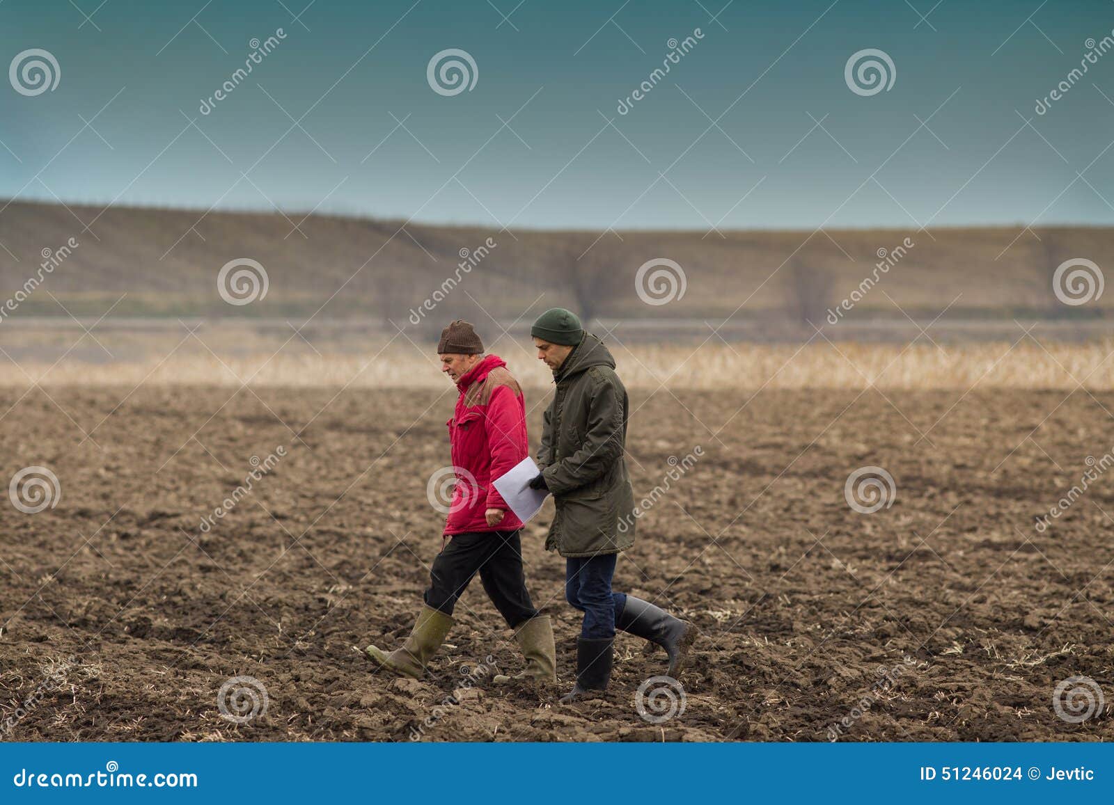 Farmers on plowed field stock photo. Image of farmland - 51246024