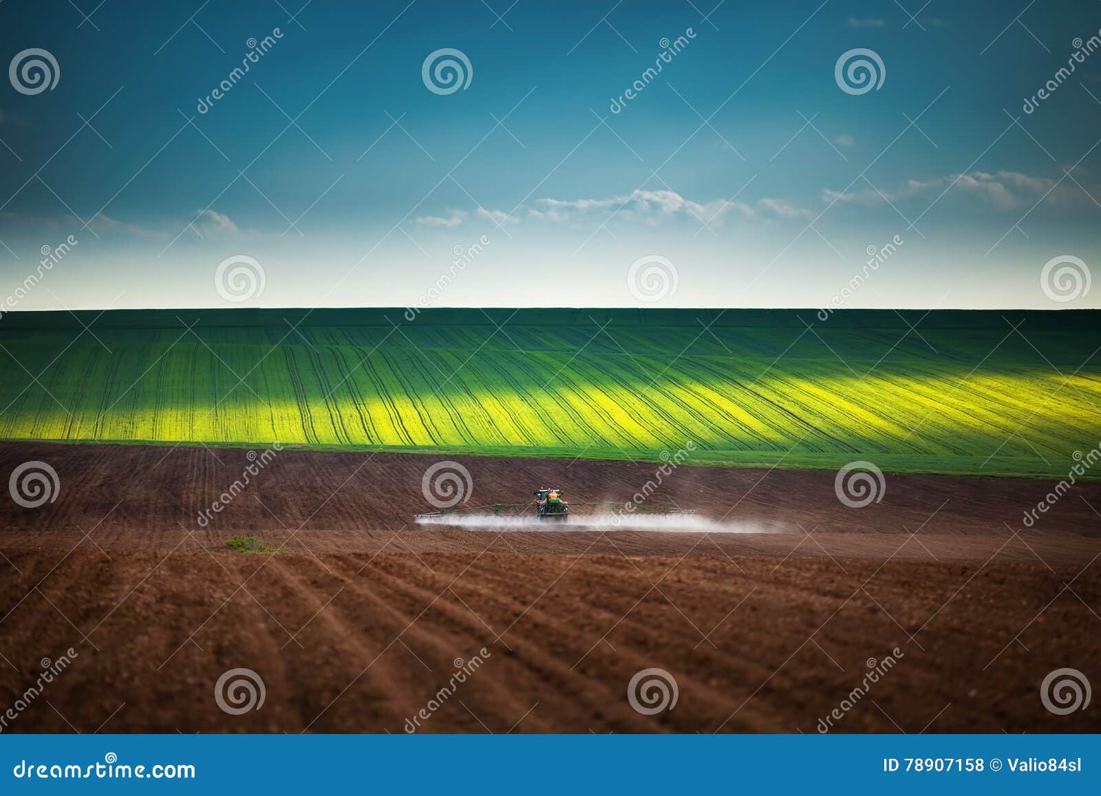 Farming Tractor Plowing and Spraying on Field Stock Photo - Image of ...