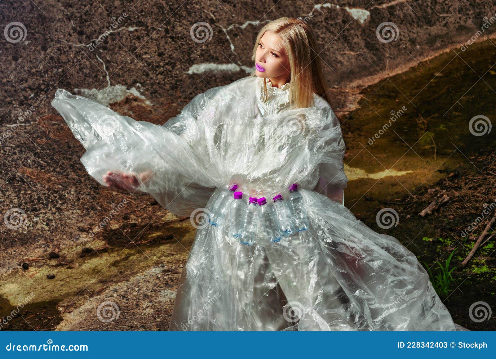 Fashion Creative. Model Posing in Cellophane with Plastic Bottles Stock ...