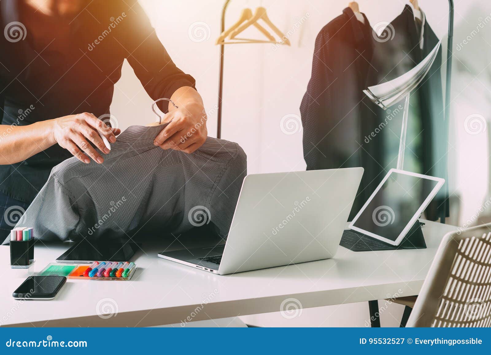 Fashion Designer Holding Shirt and Using Laptop with Digital Tab Stock ...