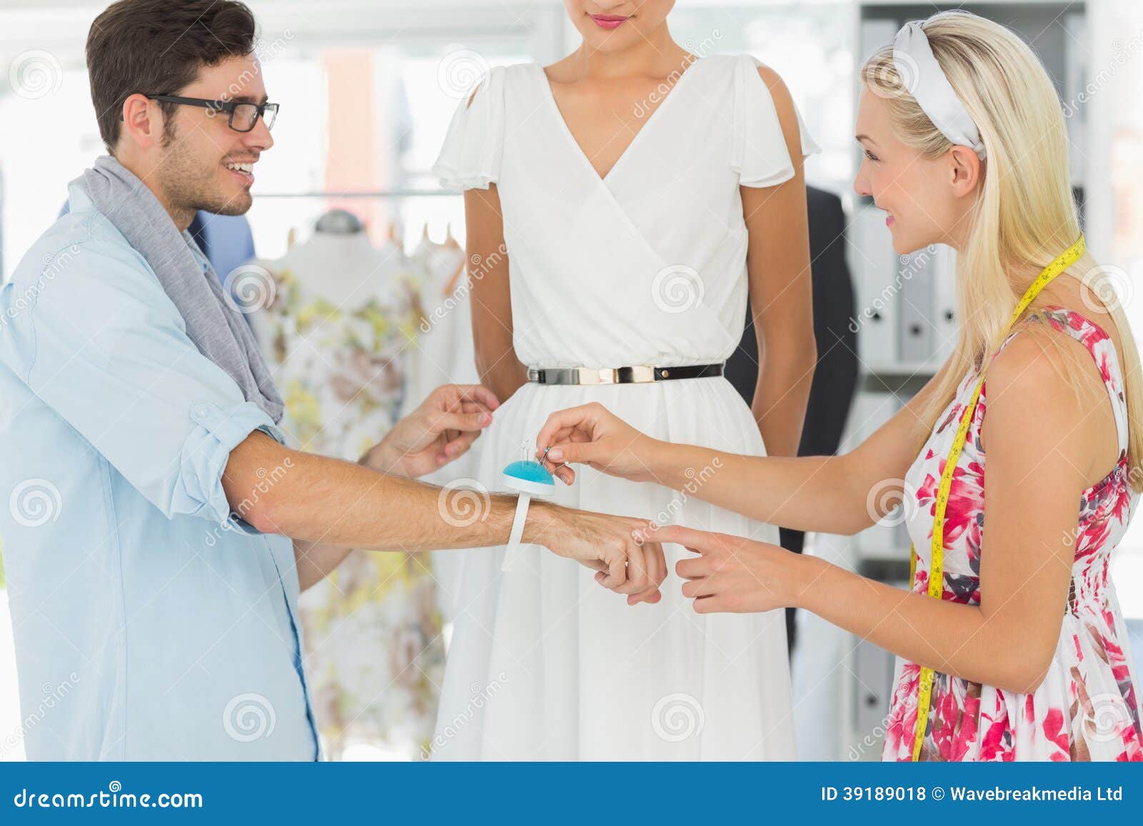 Fashion Designers Adjusting Dress on Model Stock Photo - Image of ...